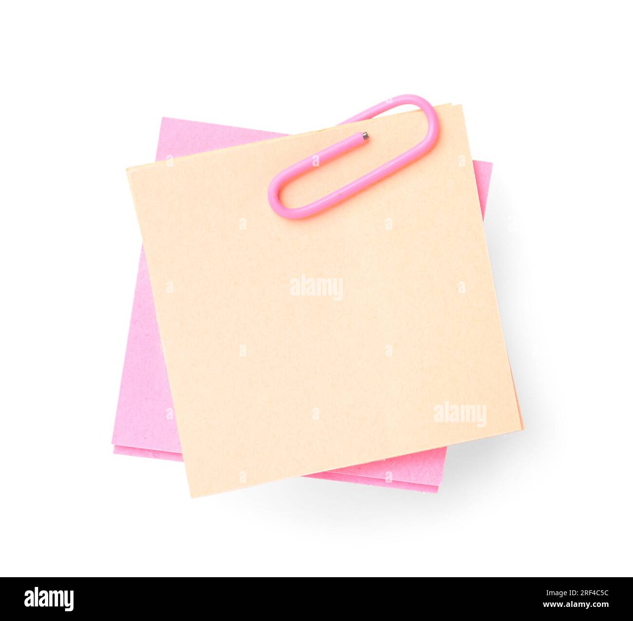 Pink and beige sticky notes with paper clip on white background Stock ...