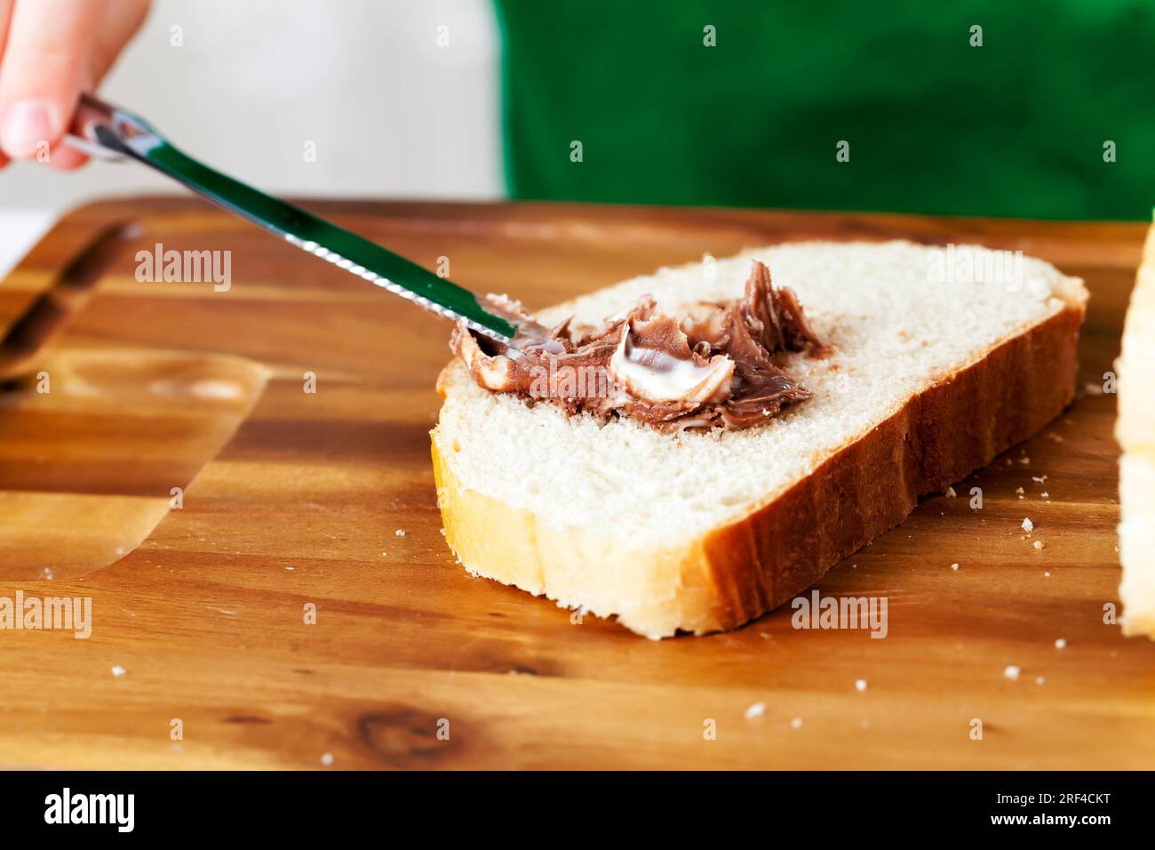 child with chocolate paste and a loaf, a child prepares sweets in the ...