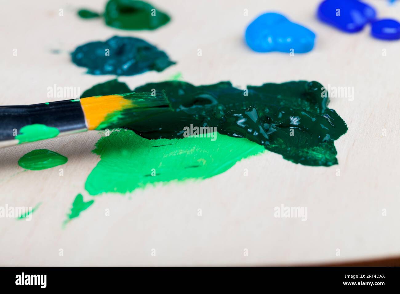 the creative process of drawing by mixing different colors of paints ...