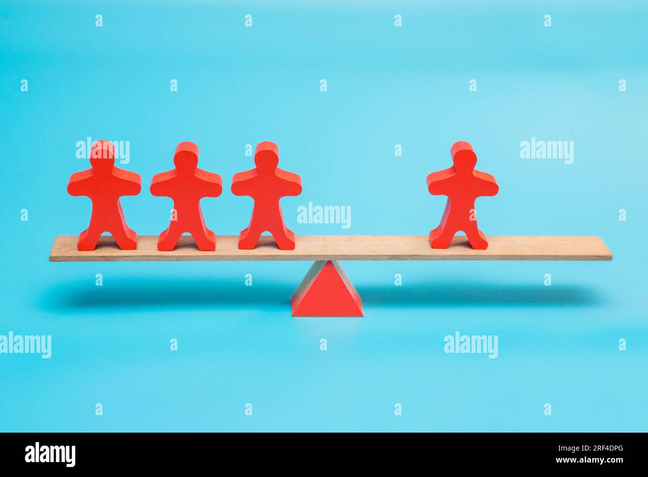 Human figurine has equal weight against a group of people Stock Photo ...