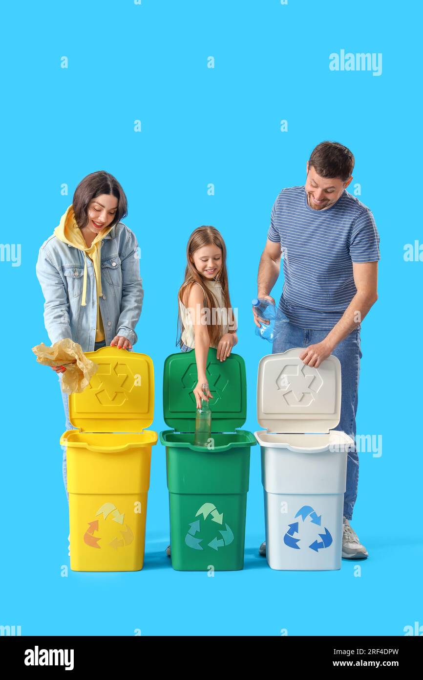 Family sorting garbage in recycle bins on blue background Stock Photo ...