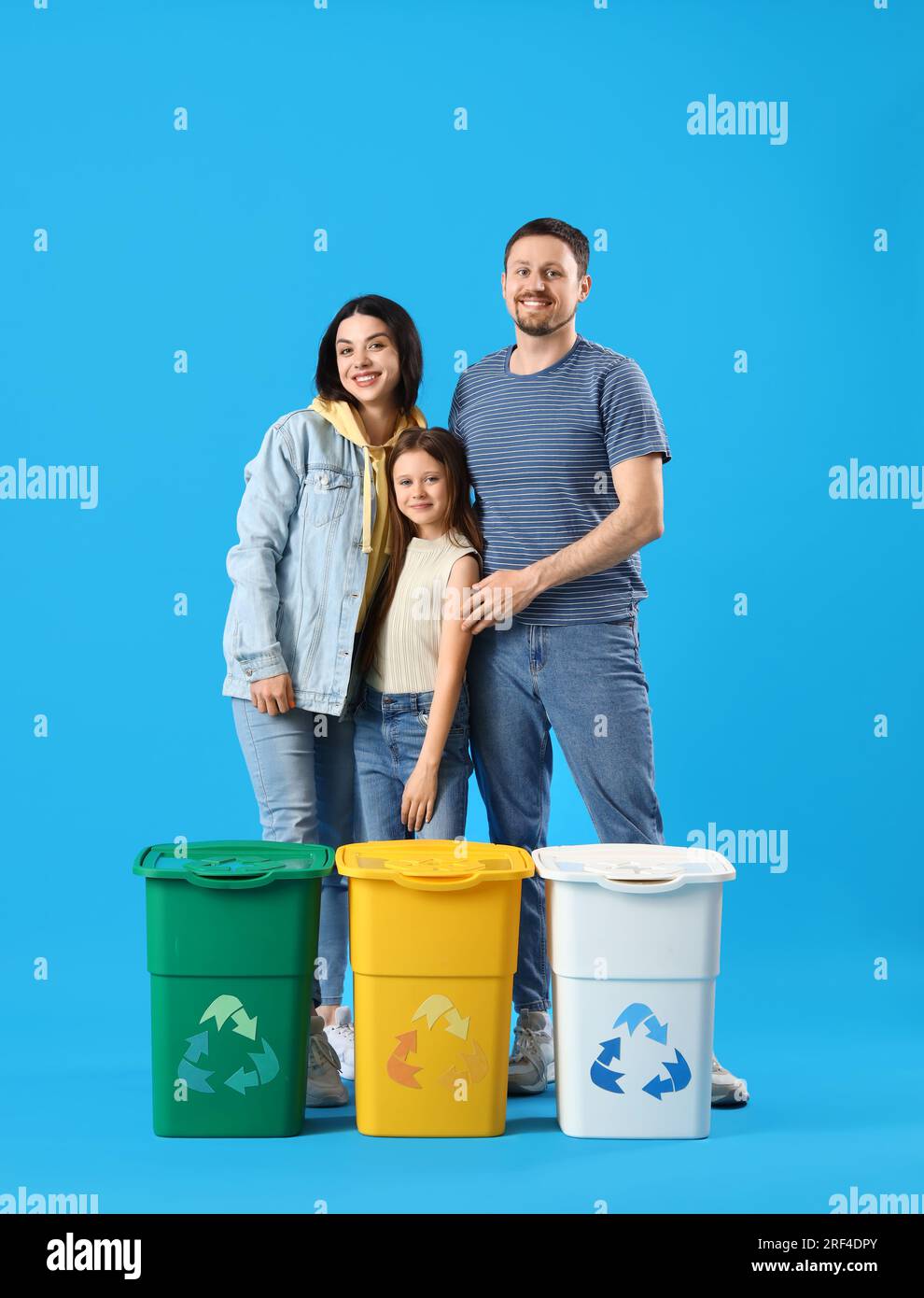 Family with recycle bins on blue background Stock Photo - Alamy