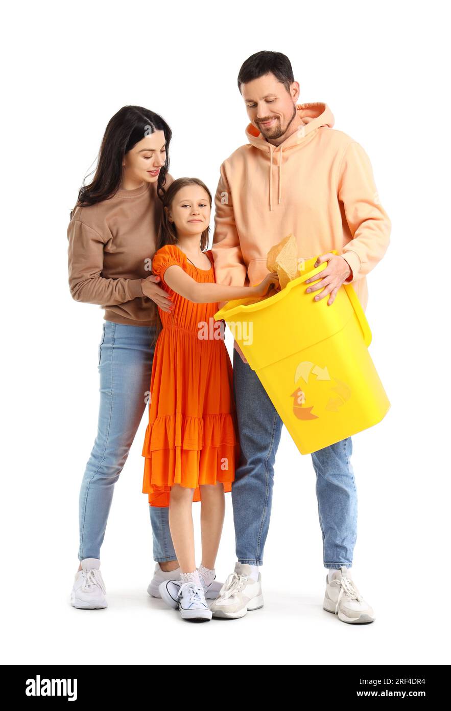 Little girl with her parents throwing paper garbage in recycle bin on ...
