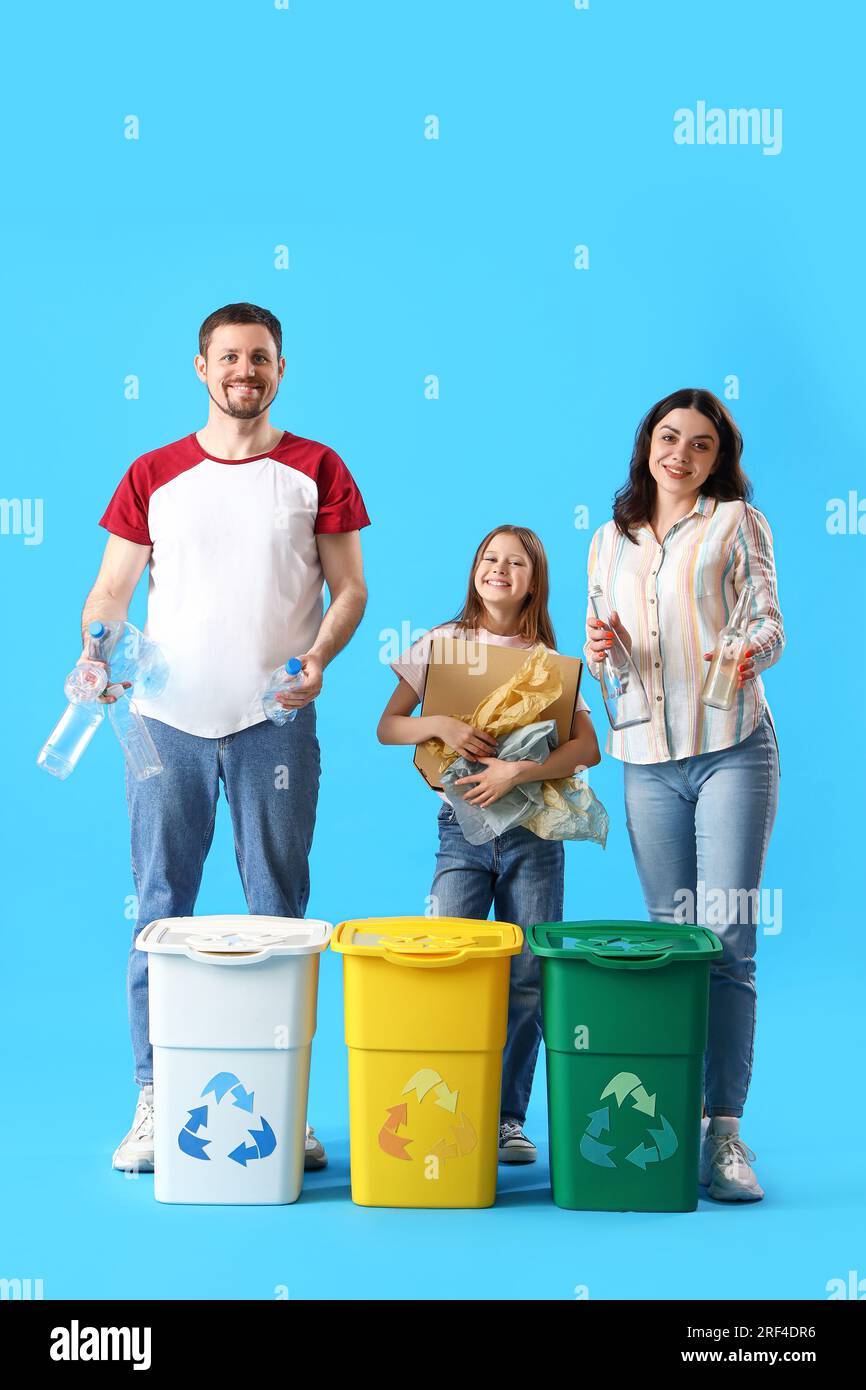 Family sorting garbage with recycle bins on blue background Stock Photo ...