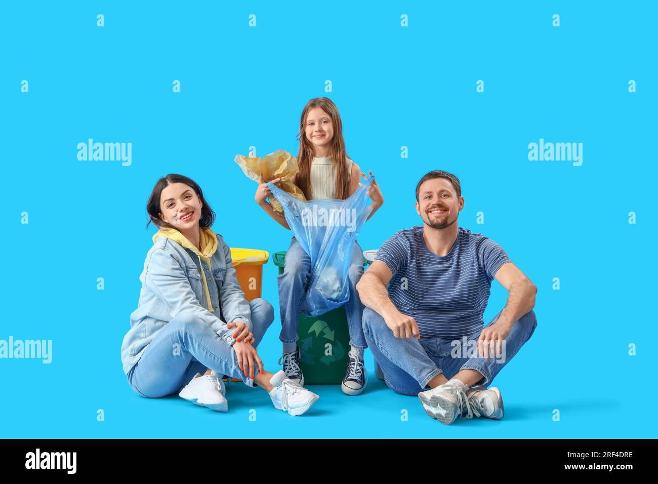 Family sorting garbage with recycle bins on blue background Stock Photo ...