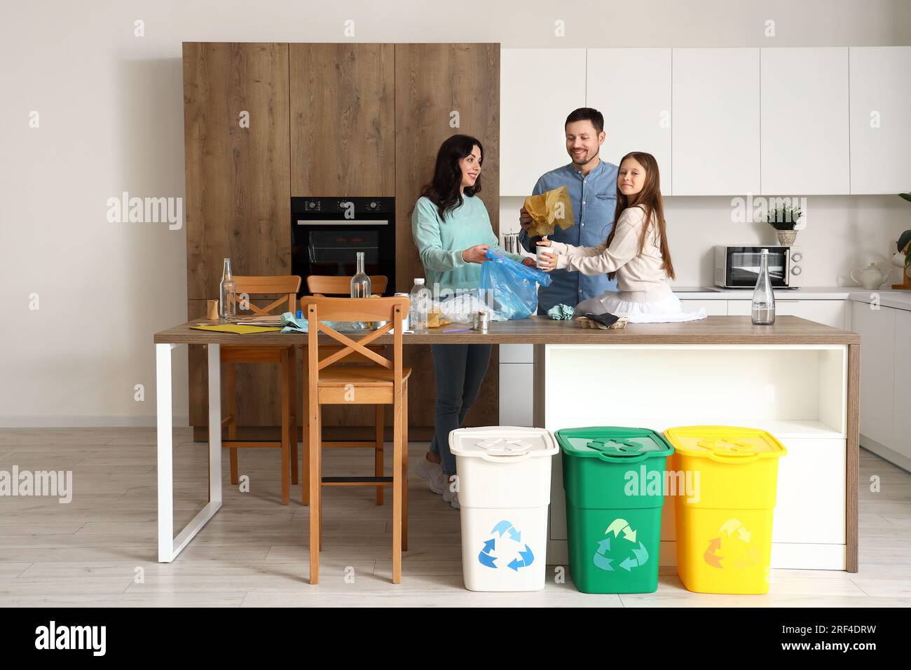 Mother daughter sorting recycling waste kitchen hi-res stock ...
