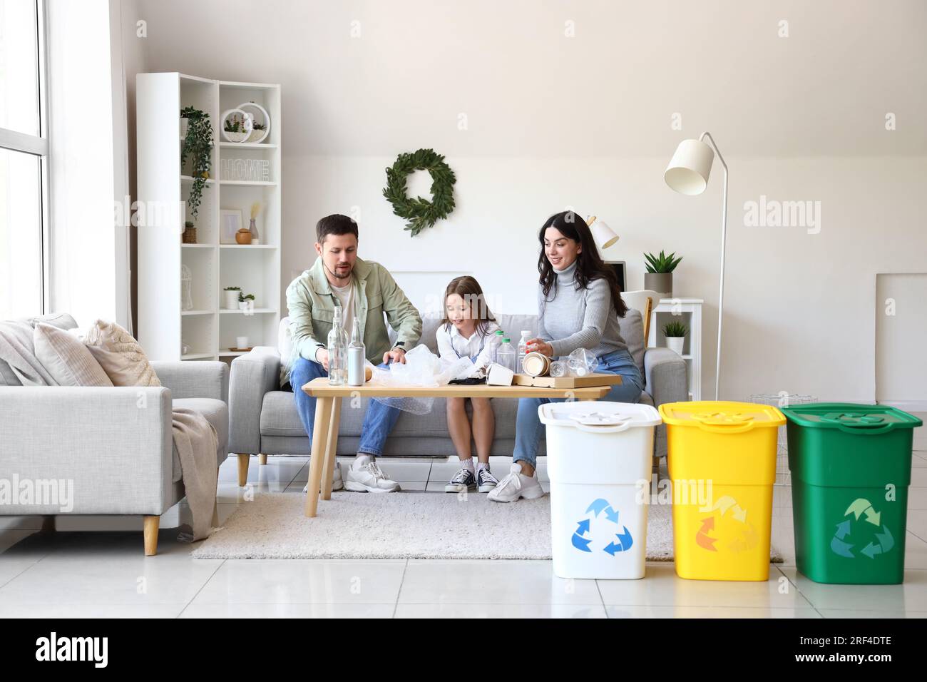 Family sorting garbage at home Stock Photo - Alamy