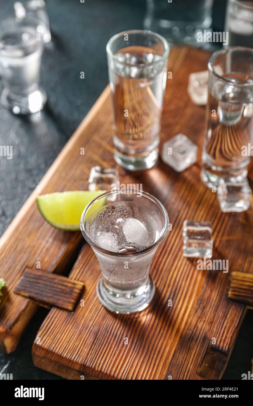 Glasses of cold vodka on black background Stock Photo - Alamy