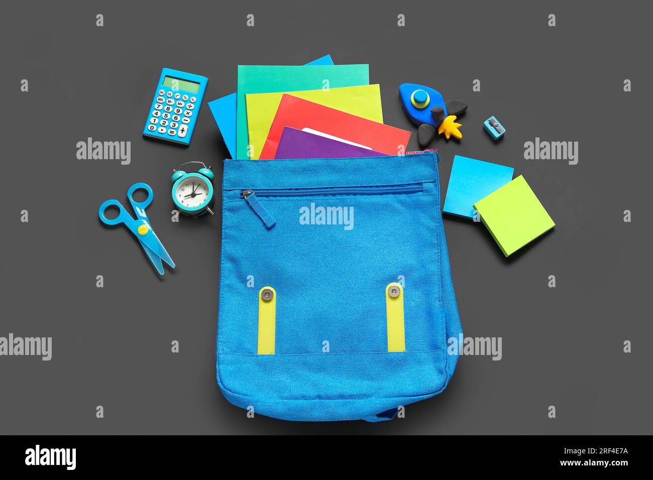 Backpack with rocket made of plasticine and different stationery on ...