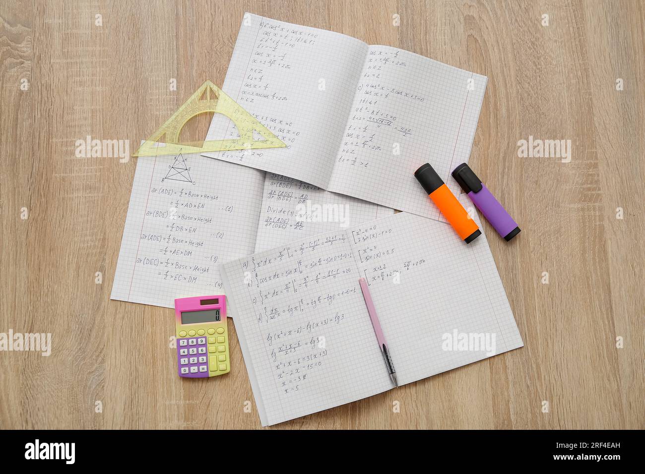 Open copybooks with math formulas and stationery on wooden table Stock ...