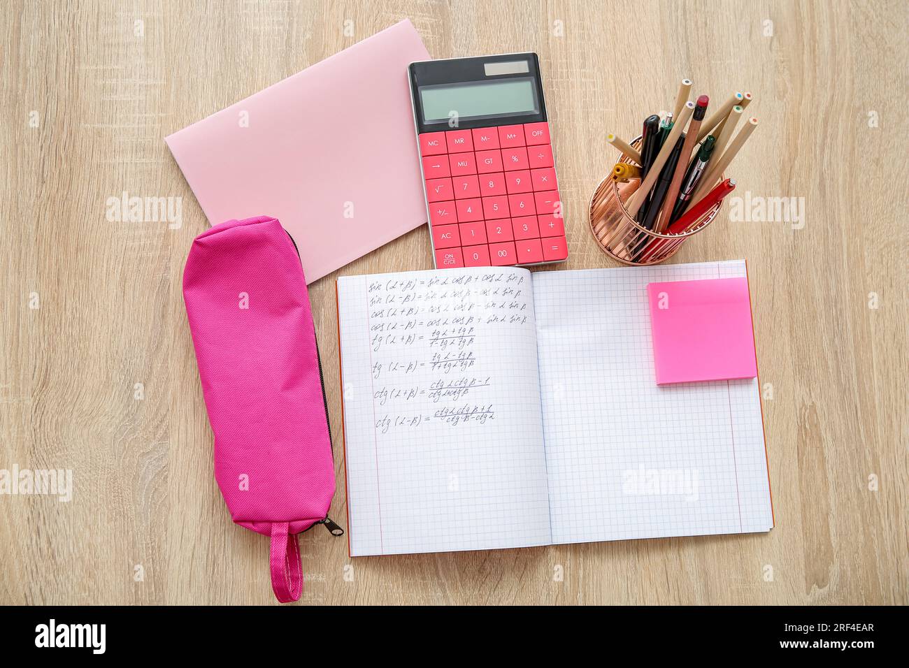 Open copybook with math formulas and stationery on wooden table Stock ...