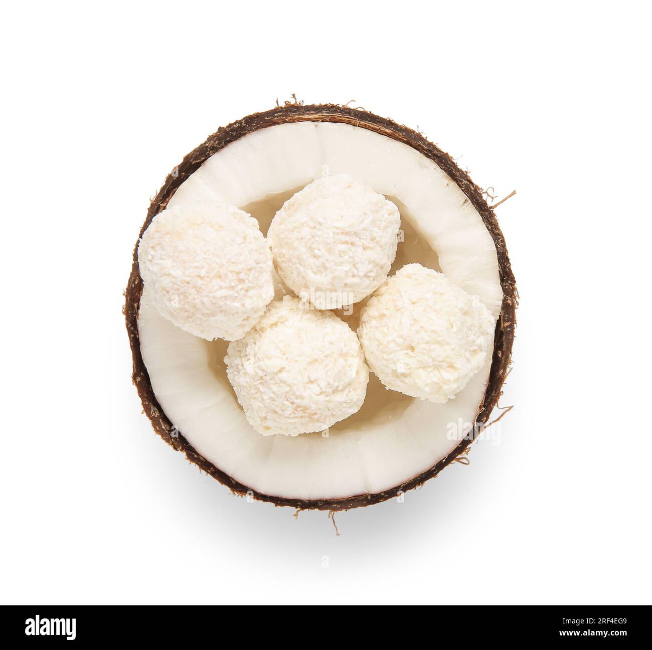 Coconut with delicious chocolate candies isolated on white background ...