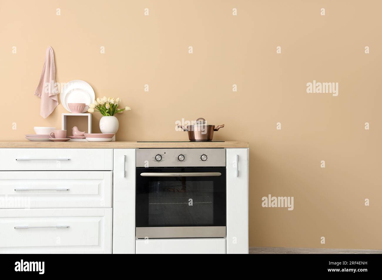 Kitchen counters with clean dishes, oven, electric stove and cooking ...