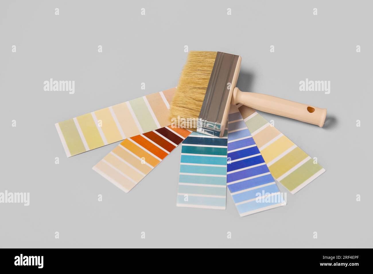 Many color palettes and brush on grey background Stock Photo - Alamy