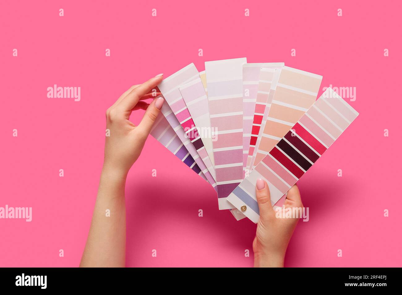 Hands with color palettes on pink background Stock Photo - Alamy