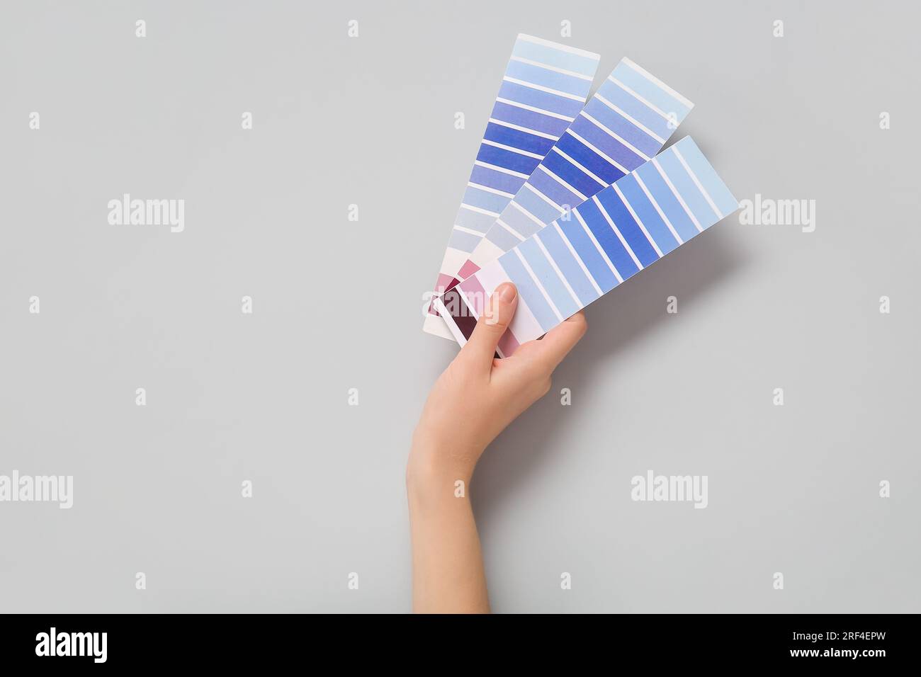 Hand with color palettes on grey background Stock Photo - Alamy