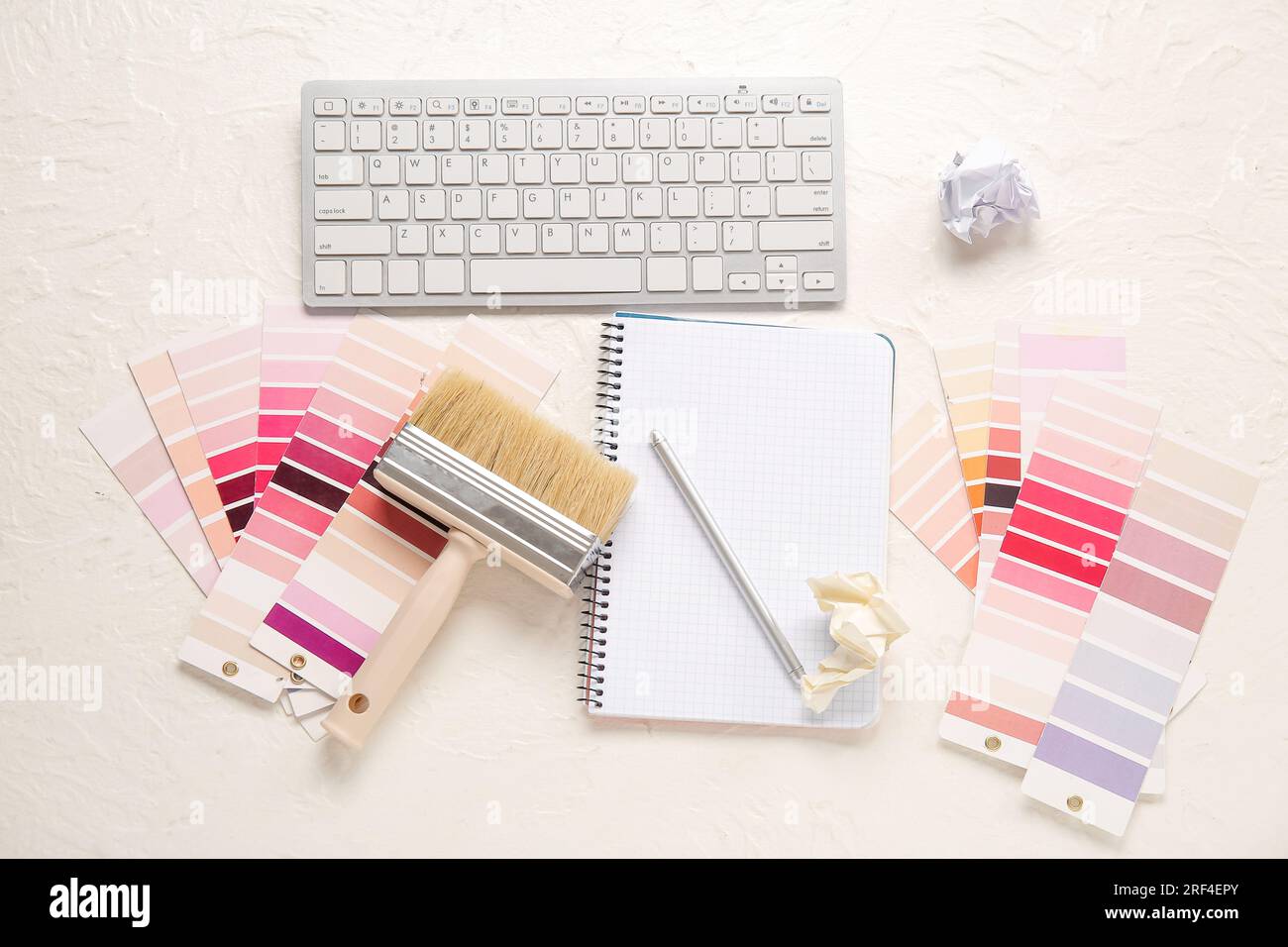 Color palettes, PC keyboard, notebook and brush on light background ...