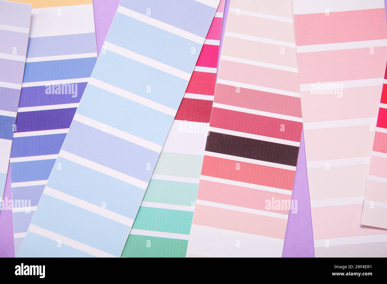 Many color palettes on lilac background Stock Photo - Alamy