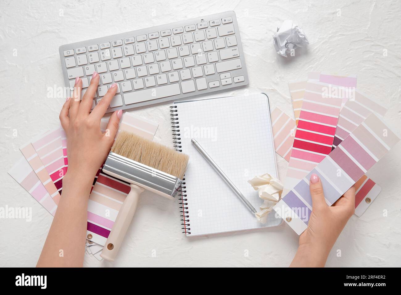 Female hands, color palettes, PC keyboard, notebook and brush on light ...