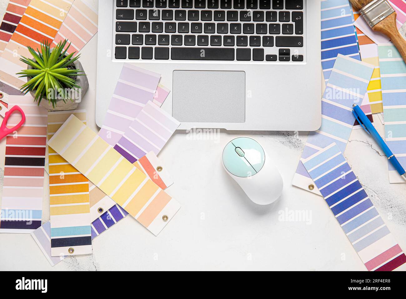 Many color palettes and laptop on light background Stock Photo - Alamy