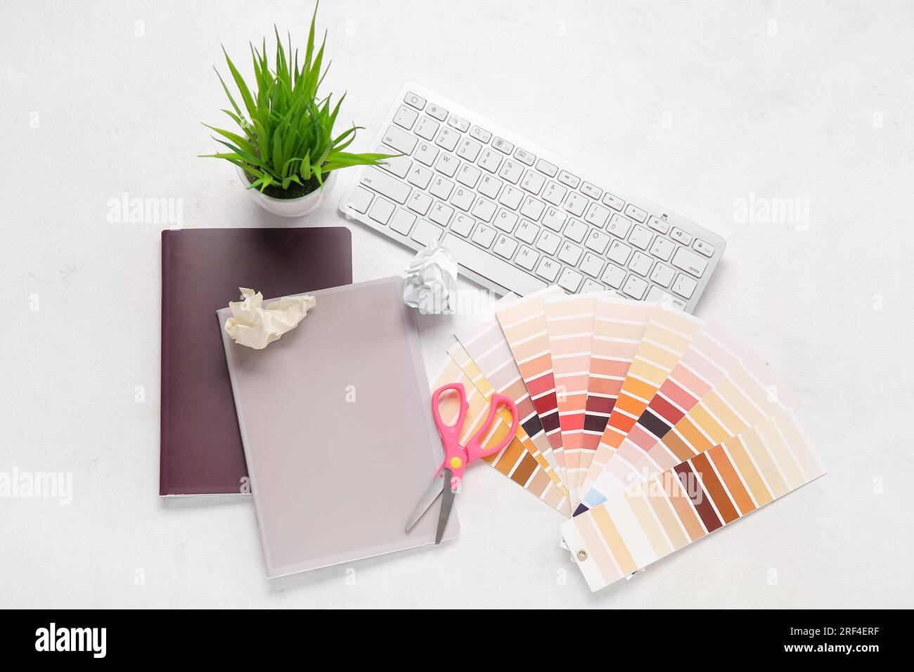 Color palettes, PC keyboard, notebooks and scissors on light background ...