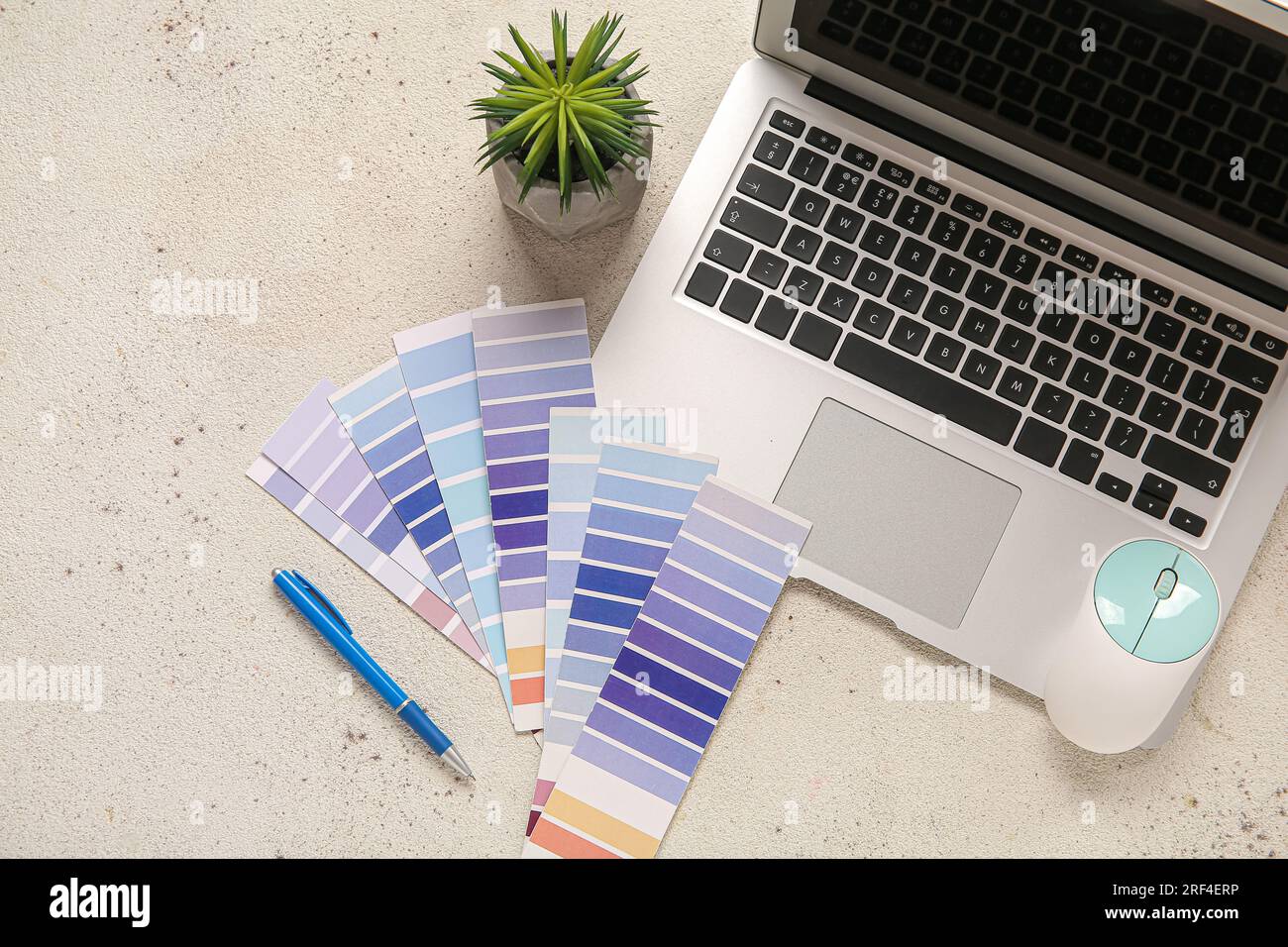 Many color palettes and laptop on light background Stock Photo - Alamy