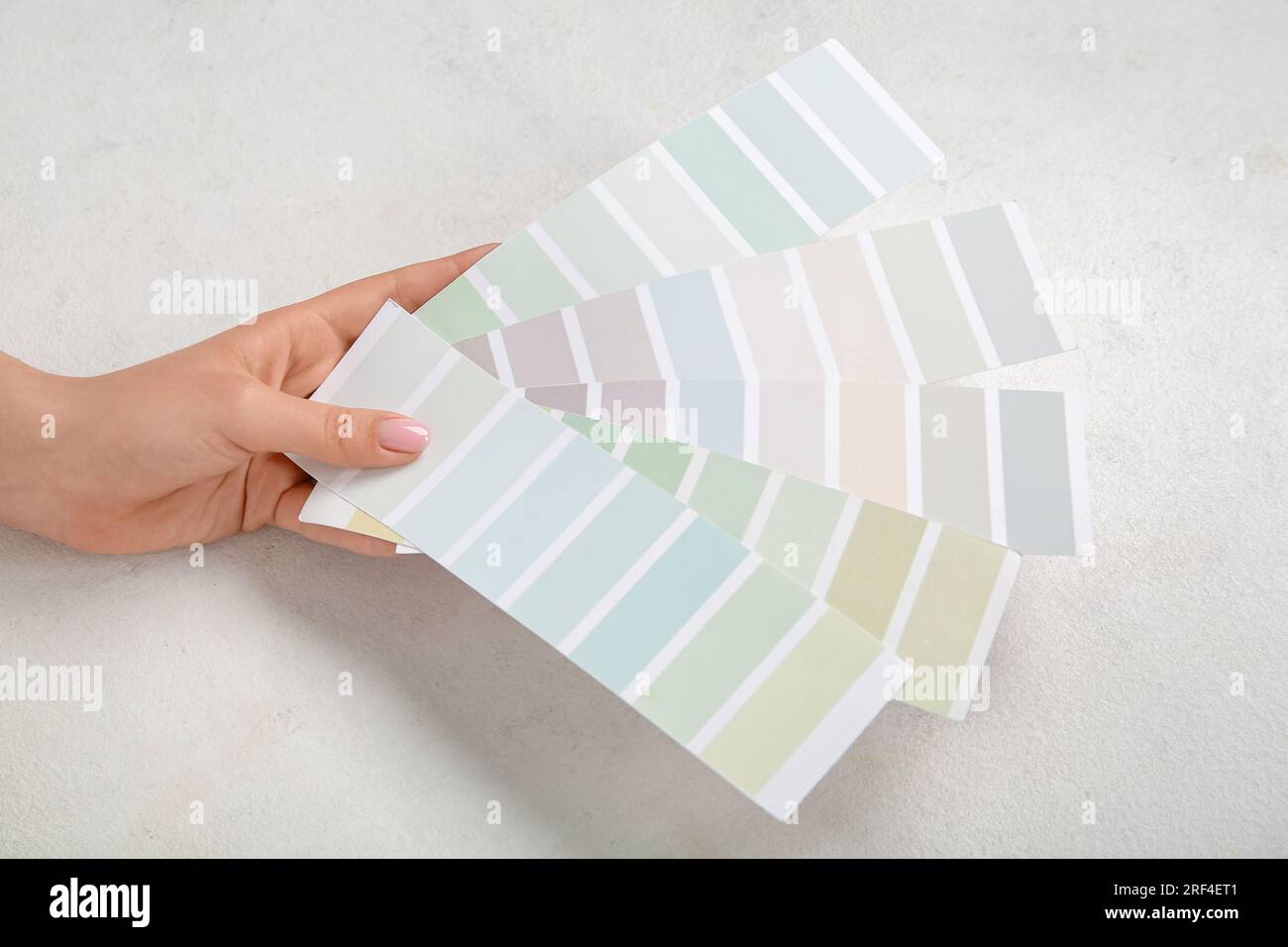 Hand with color palettes on light background Stock Photo - Alamy