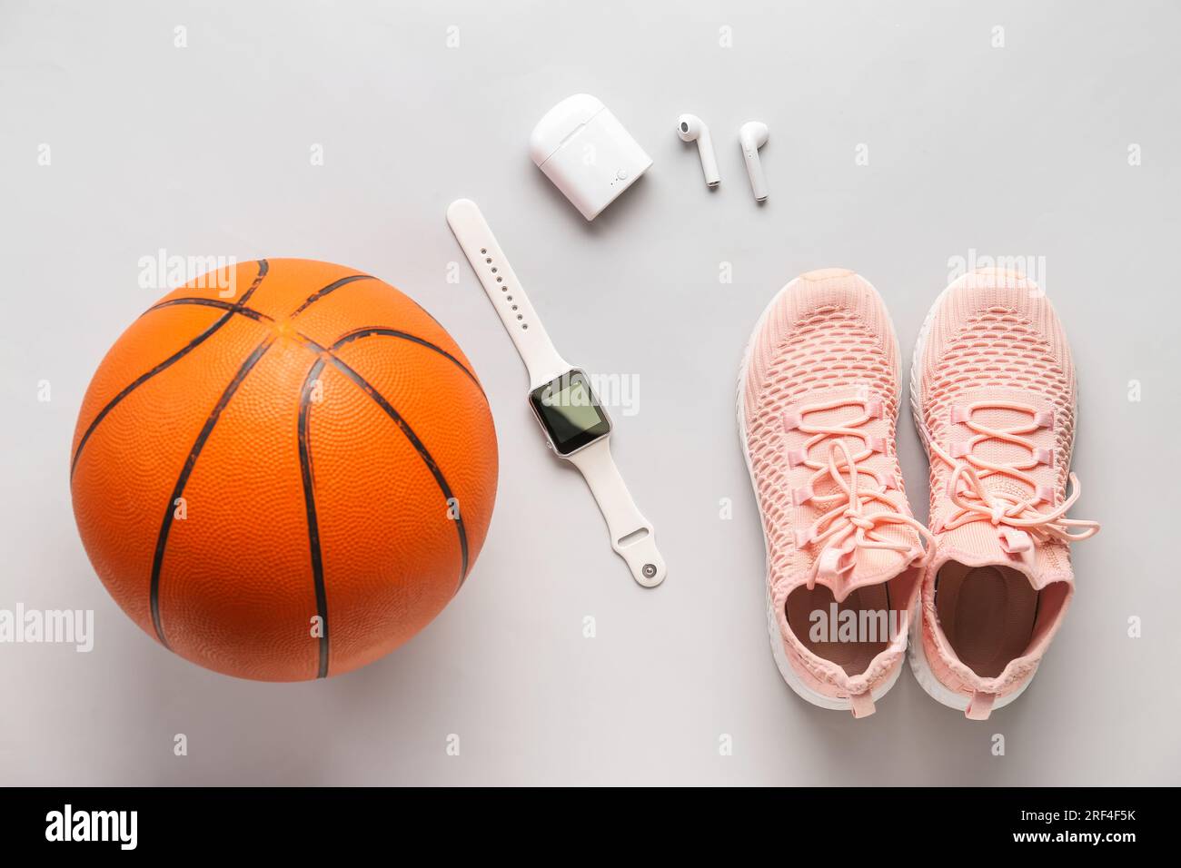 Pair of sneakers, ball for playing basketball and modern gadgets on ...
