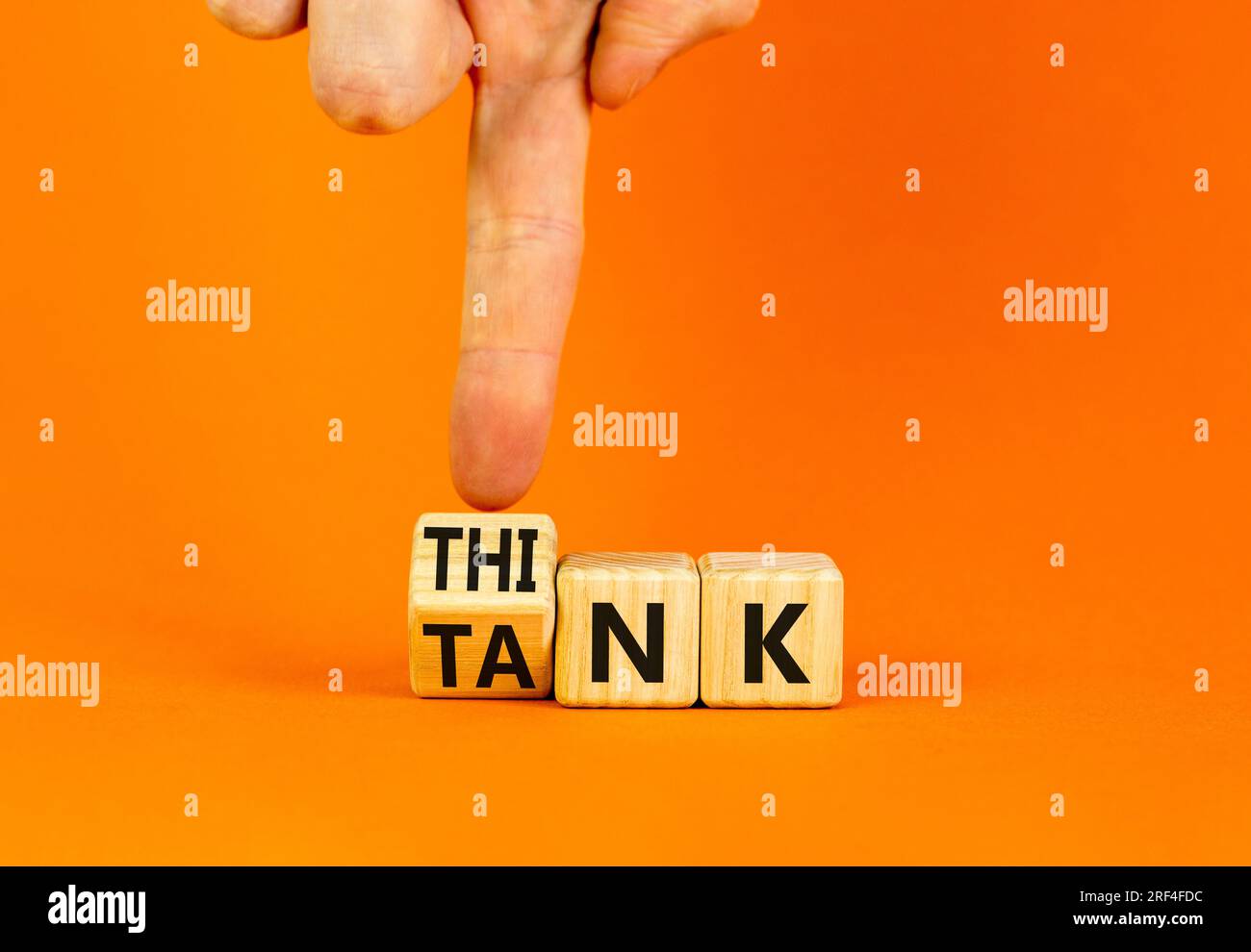 Think tank symbol. Businessman turns wooden cubes and changes the word ...