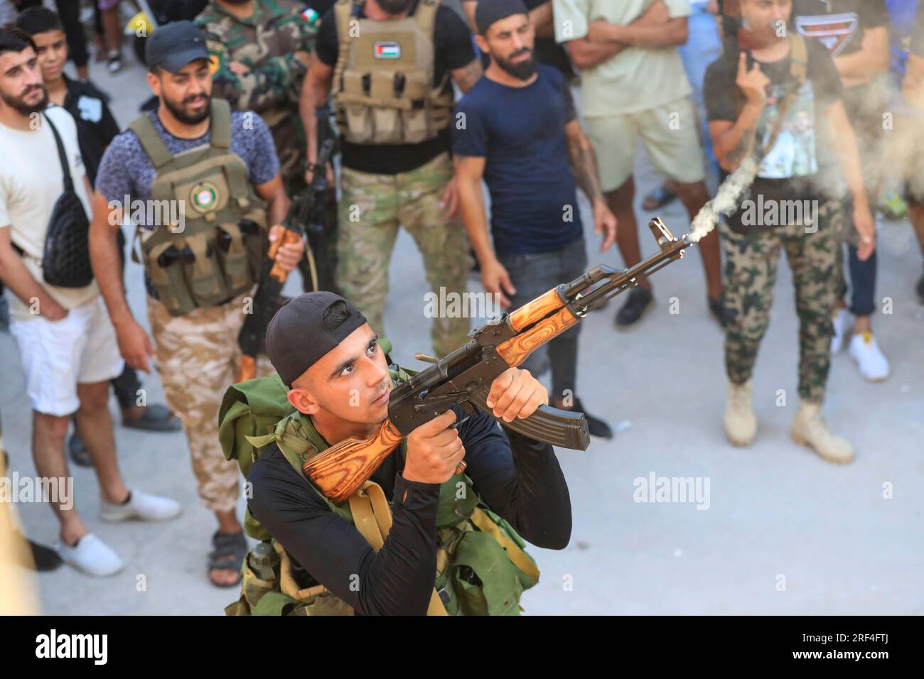 A member of the Palestinian Fatah Movement fires in the air during the ...