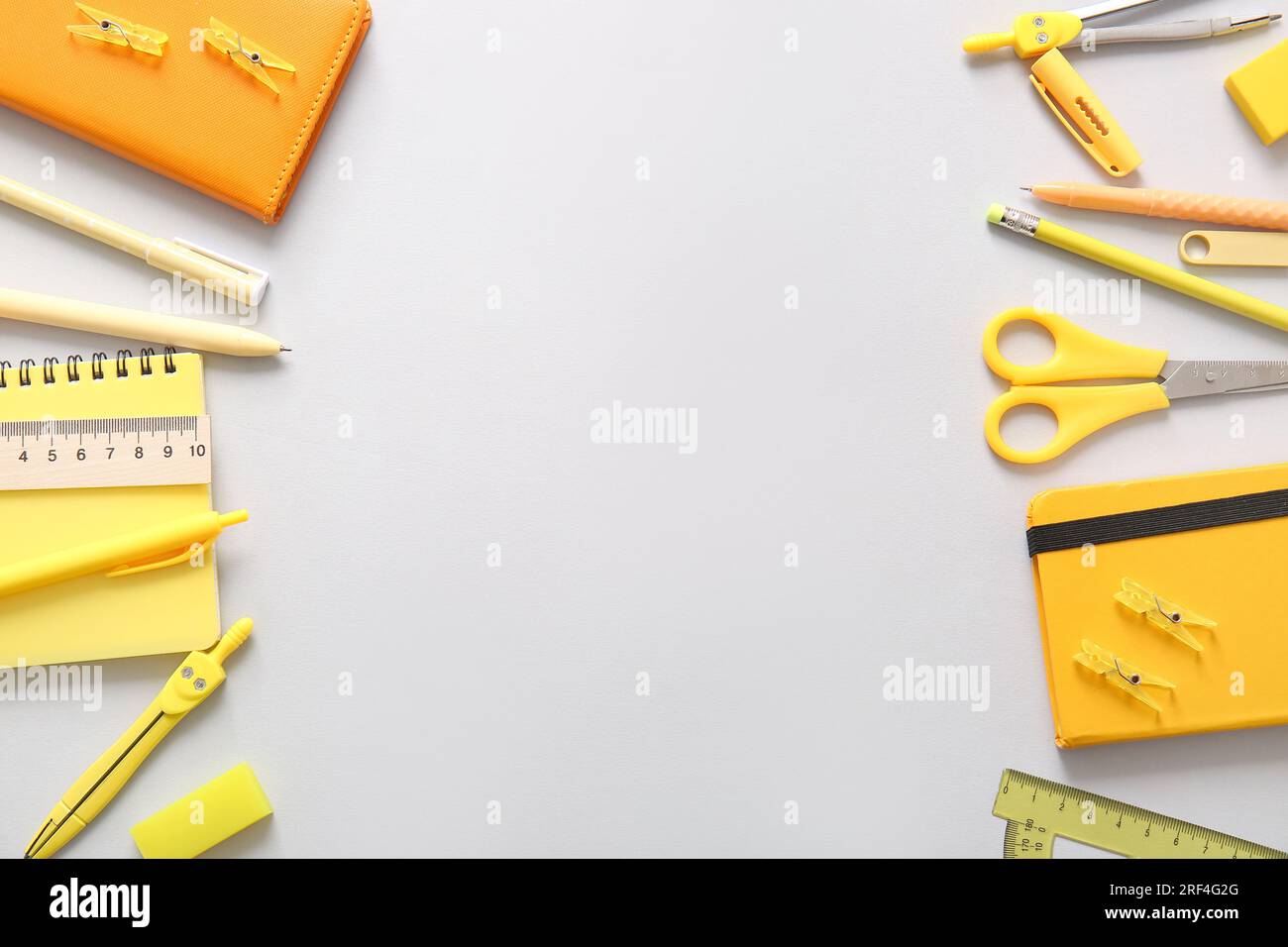 Frame made of different school stationery and notebooks on grey ...