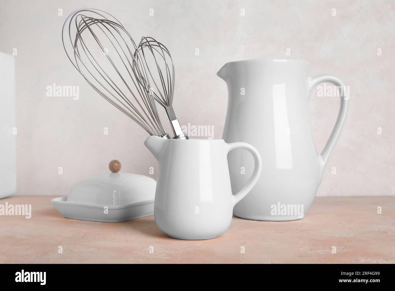 Set of different kitchen utensils on color table against light ...