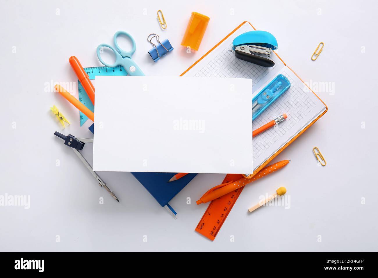Composition with blank paper sheet and different school stationery on ...