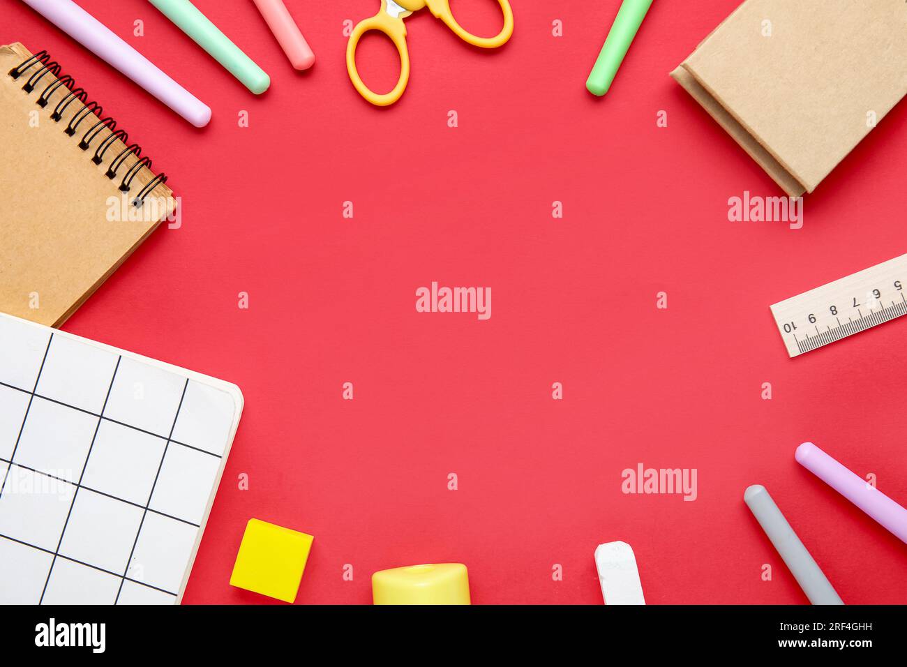 Frame made of different stationery on red background Stock Photo - Alamy