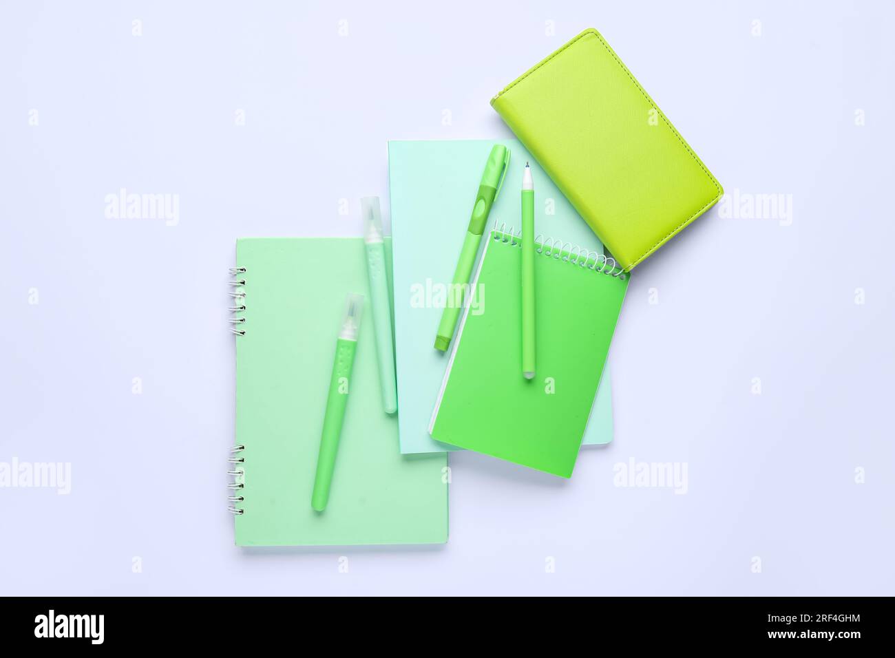 Composition with different notebooks, pens and markers on white ...