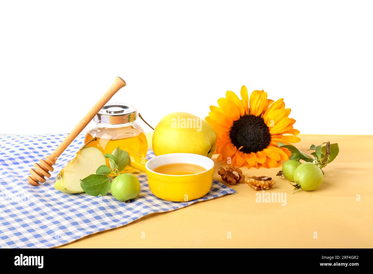 Composition with sweet honey, apples and sunflower on color table ...