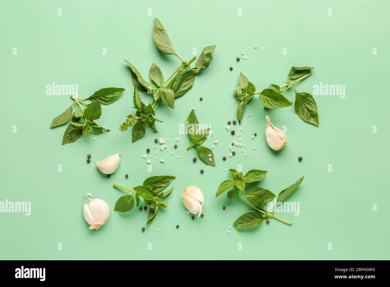 Composition with fresh aromatic basil and spices on color background ...