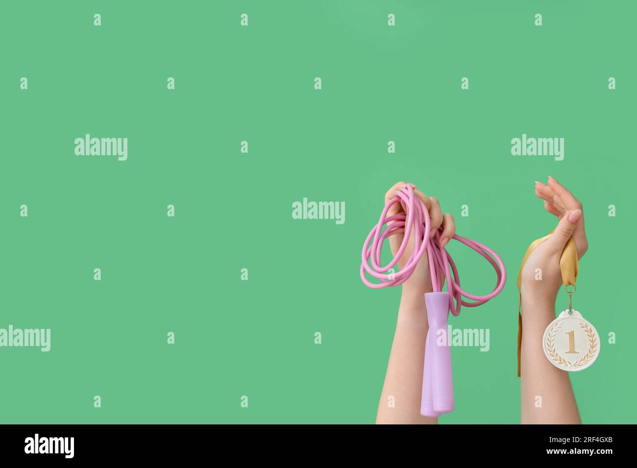 Female hands with jumping rope and medal on green background Stock ...