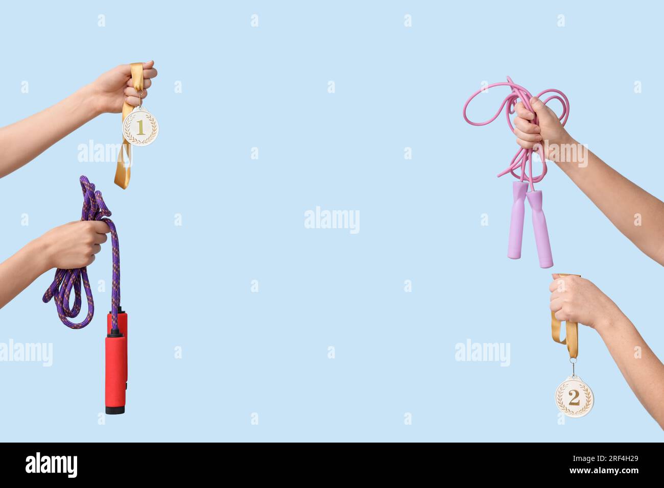 Female hands with jumping ropes and medals on blue background Stock ...