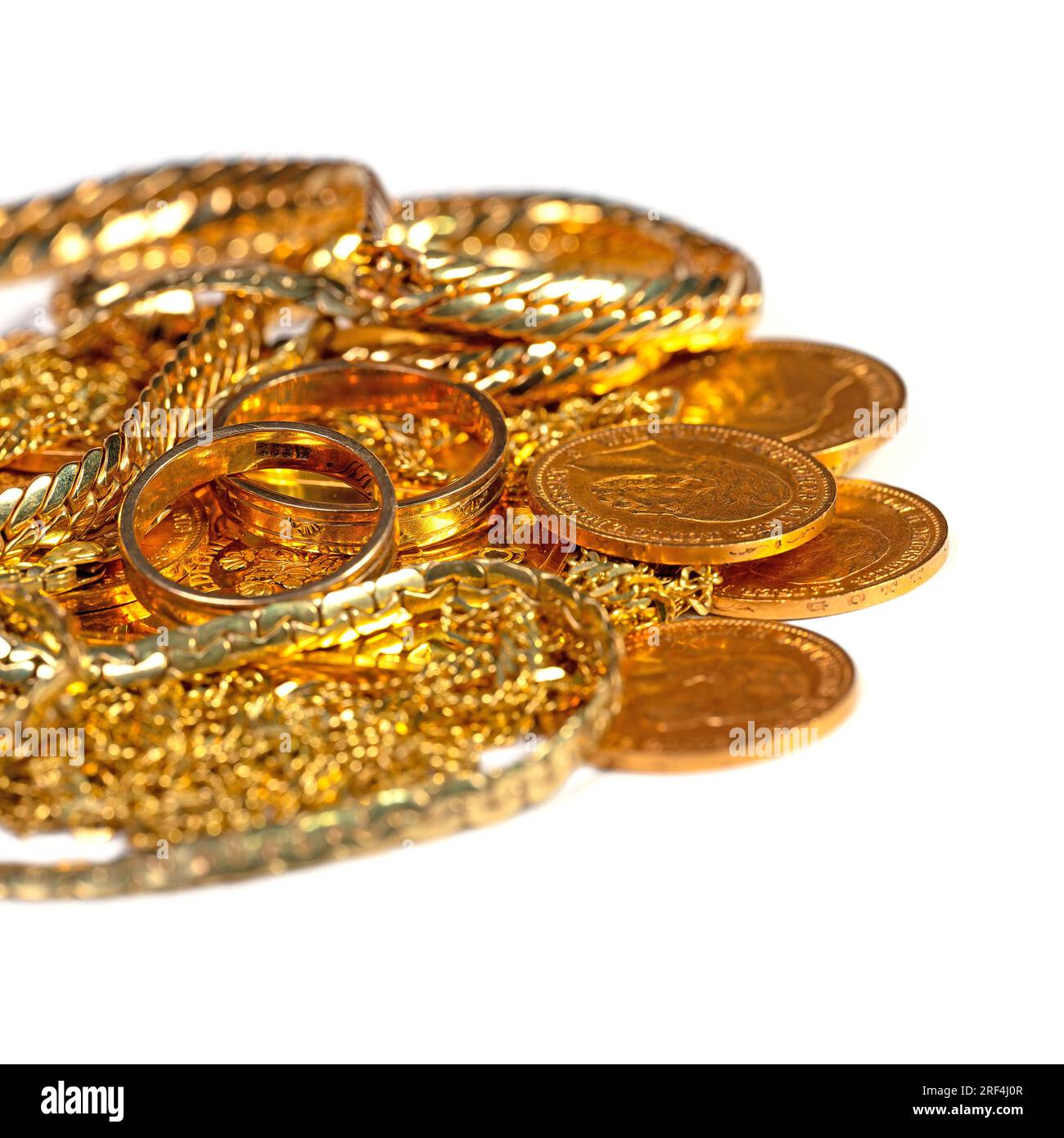 Gold jewelry, gold coins and gold bars against white background Stock ...