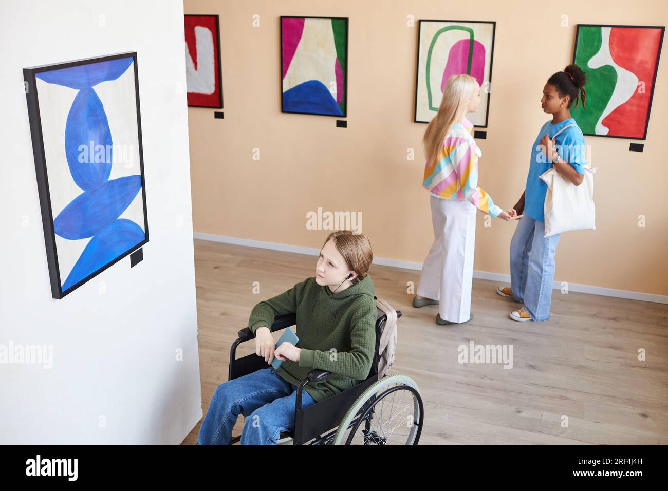 High angle portrait of teenage boy with disability looking at abstract ...