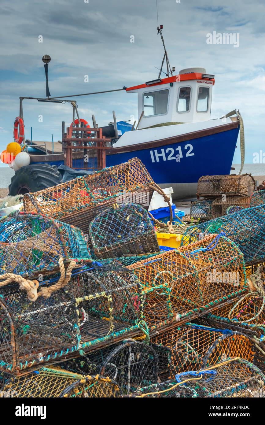 Traditional fishing boat pulled up onto the shingle beach at Aldeburgh ...