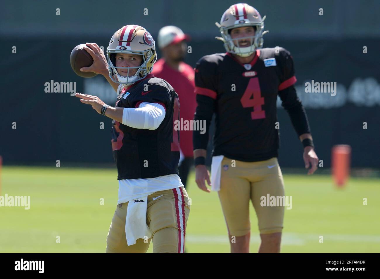 San Francisco 49ers quarterback Brock Purdy, left, passes in front of ...