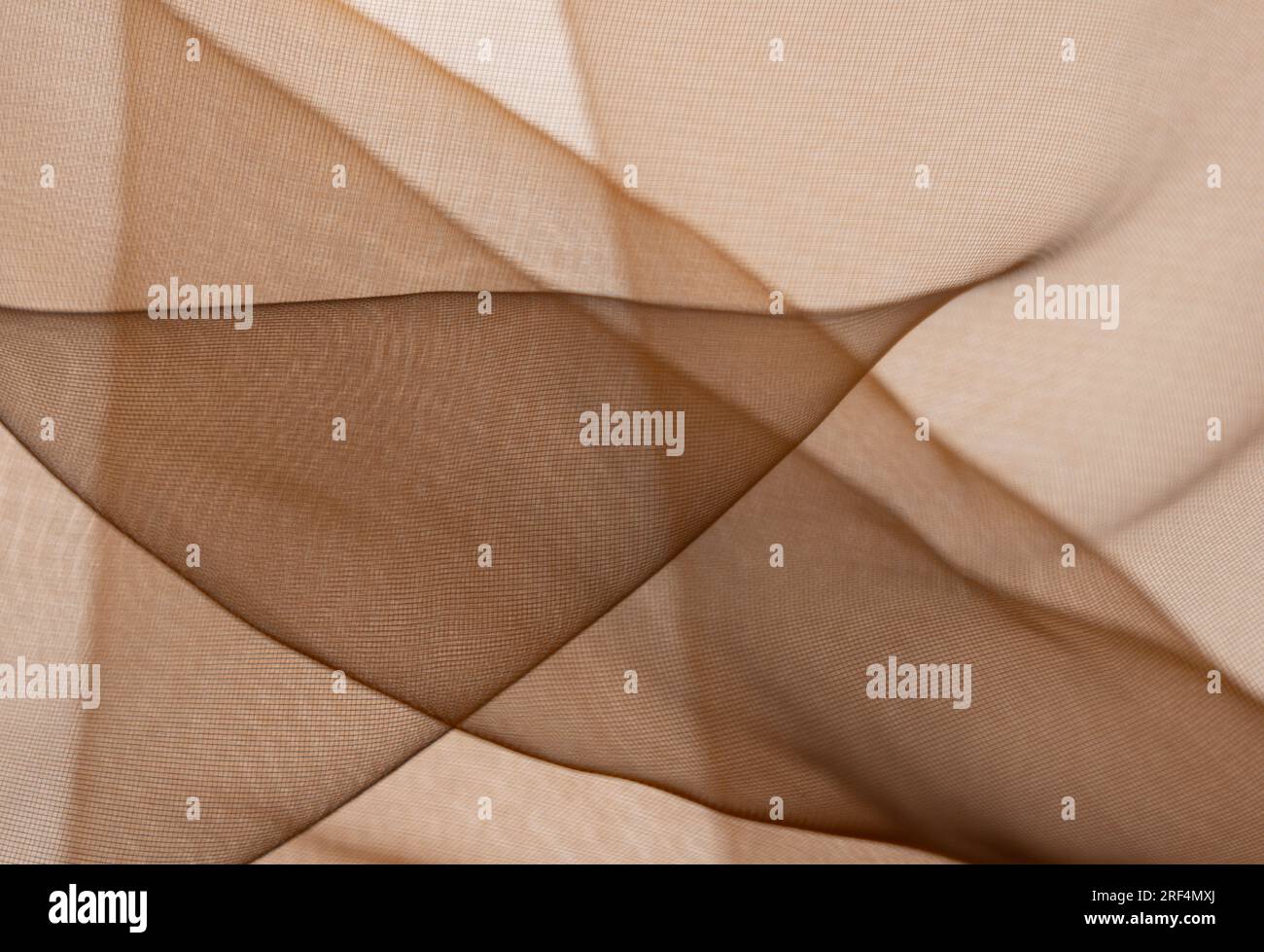 Translucent fine material in beige, brown,& tan forms triangular shapes ...