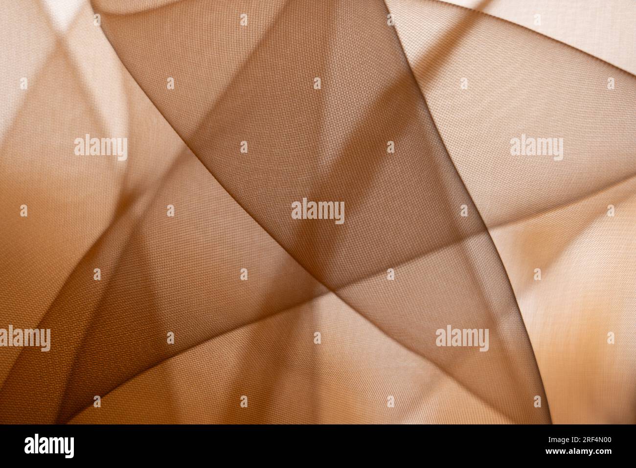 Translucent fine material in beige, brown,& tan forms triangular shapes ...