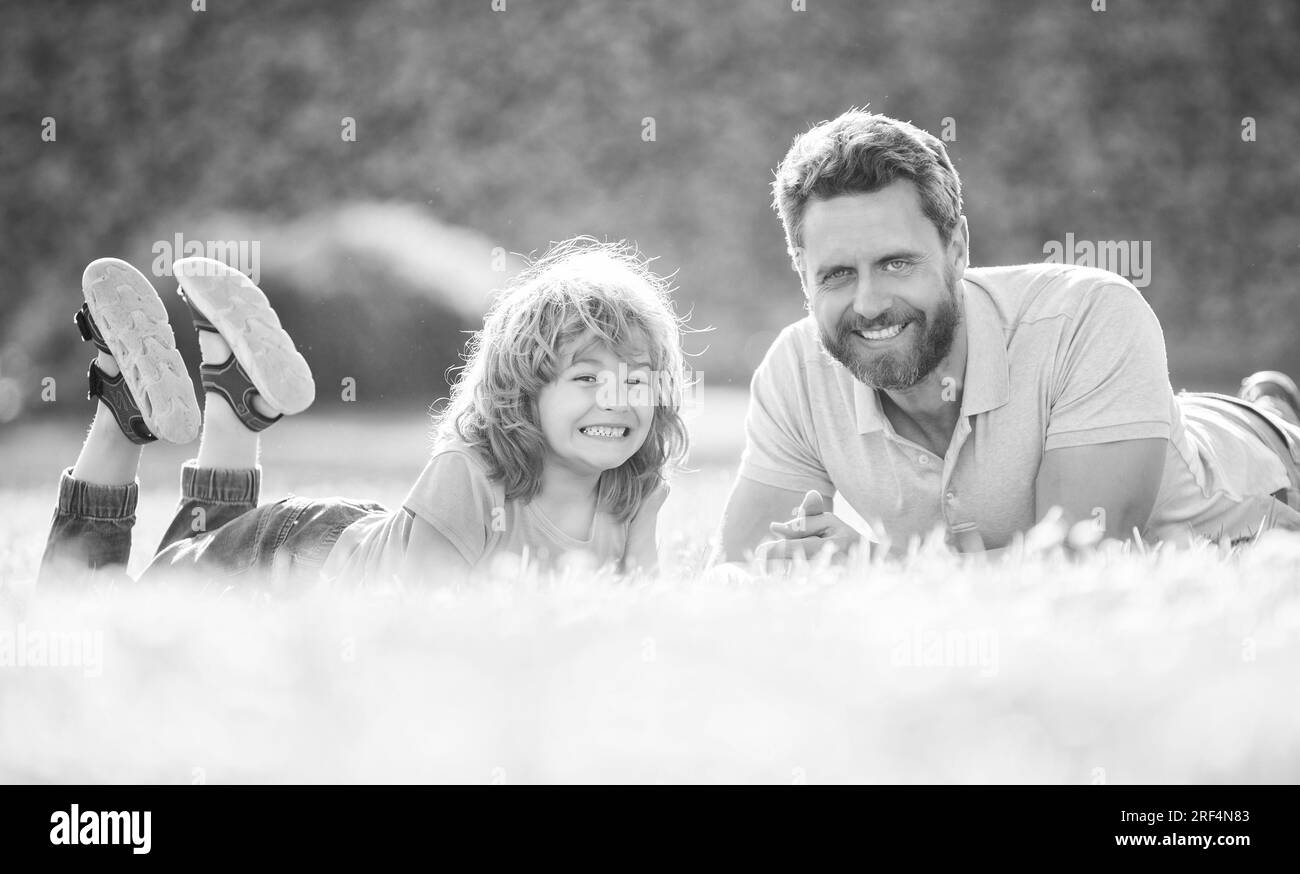 happy family of father and son child relax in summer park green grass ...