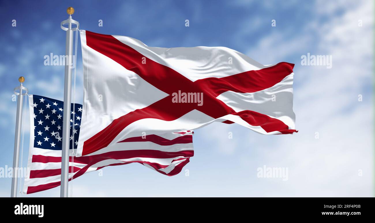 United States and Alabama flags waving together on a sunny day. The ...
