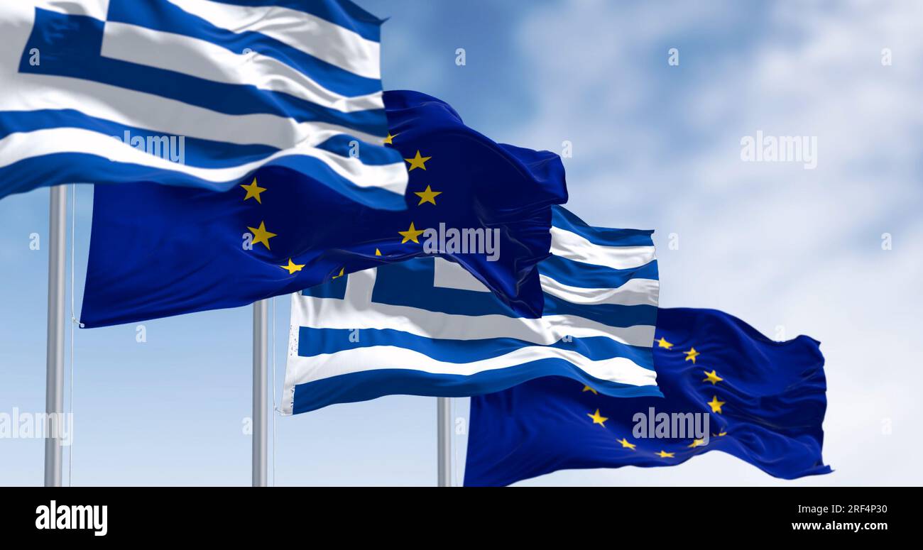 The flags of Greece and the European Union waving together on a clear ...