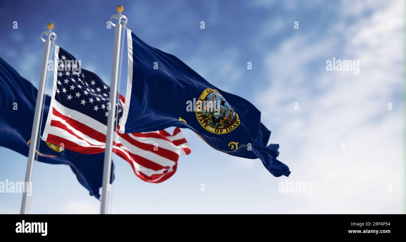 The Idaho state flag waving along with the national flag of the United ...