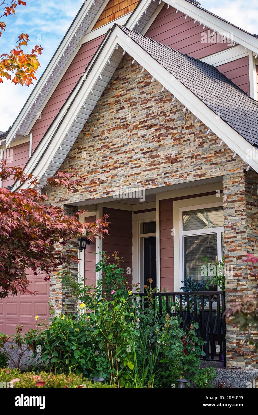 Entrance to a home through a beautiful garden with colorful flowers ...